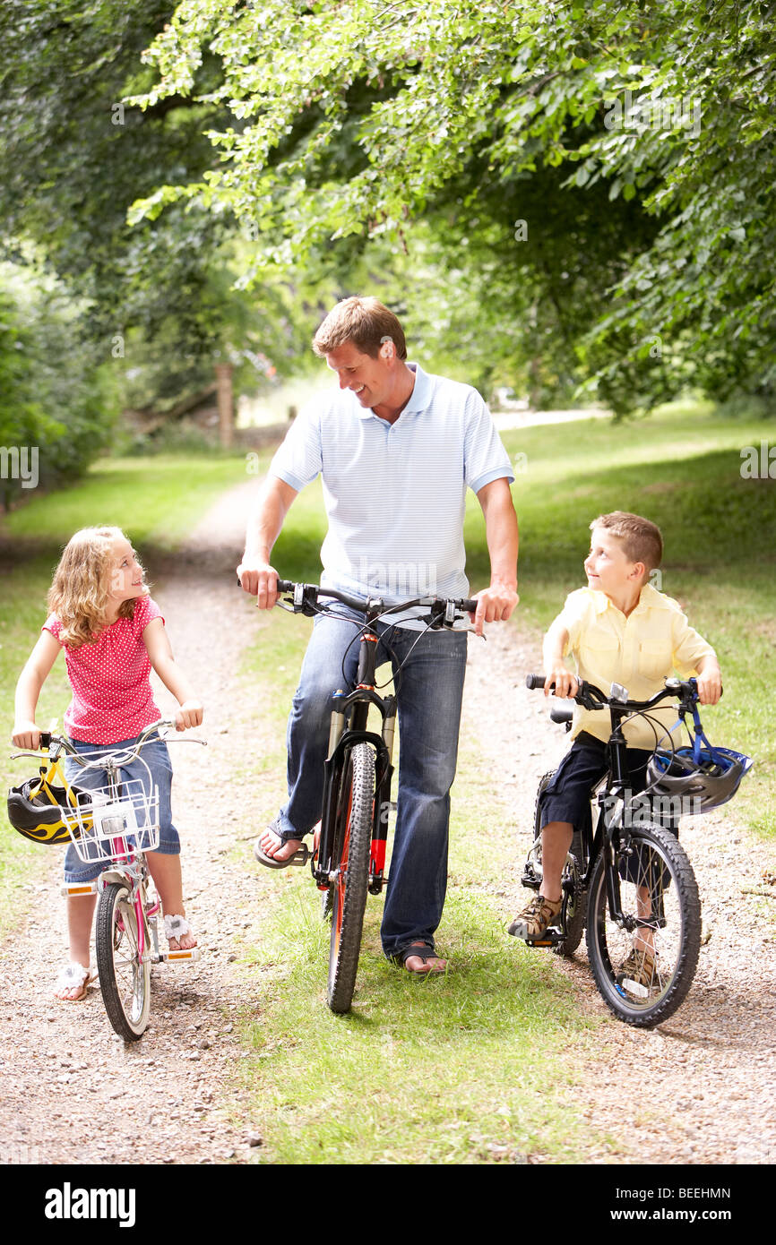 Father and children riding bikes in countryside Stock Photo - Alamy