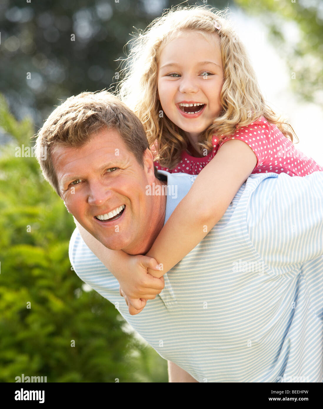 Father giving daughter piggyback Stock Photo - Alamy