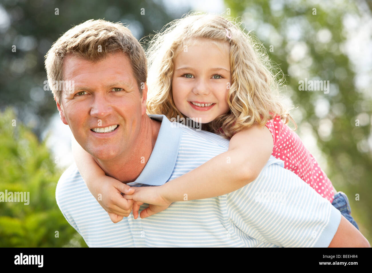 Father giving daughter piggyback Stock Photo - Alamy