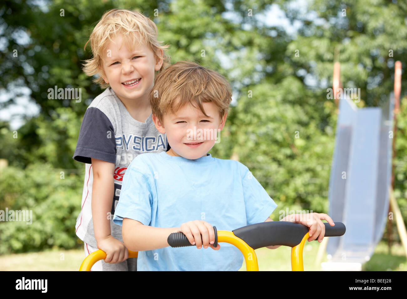 Two Young Boys Playing on Bike Stock Photo - Alamy