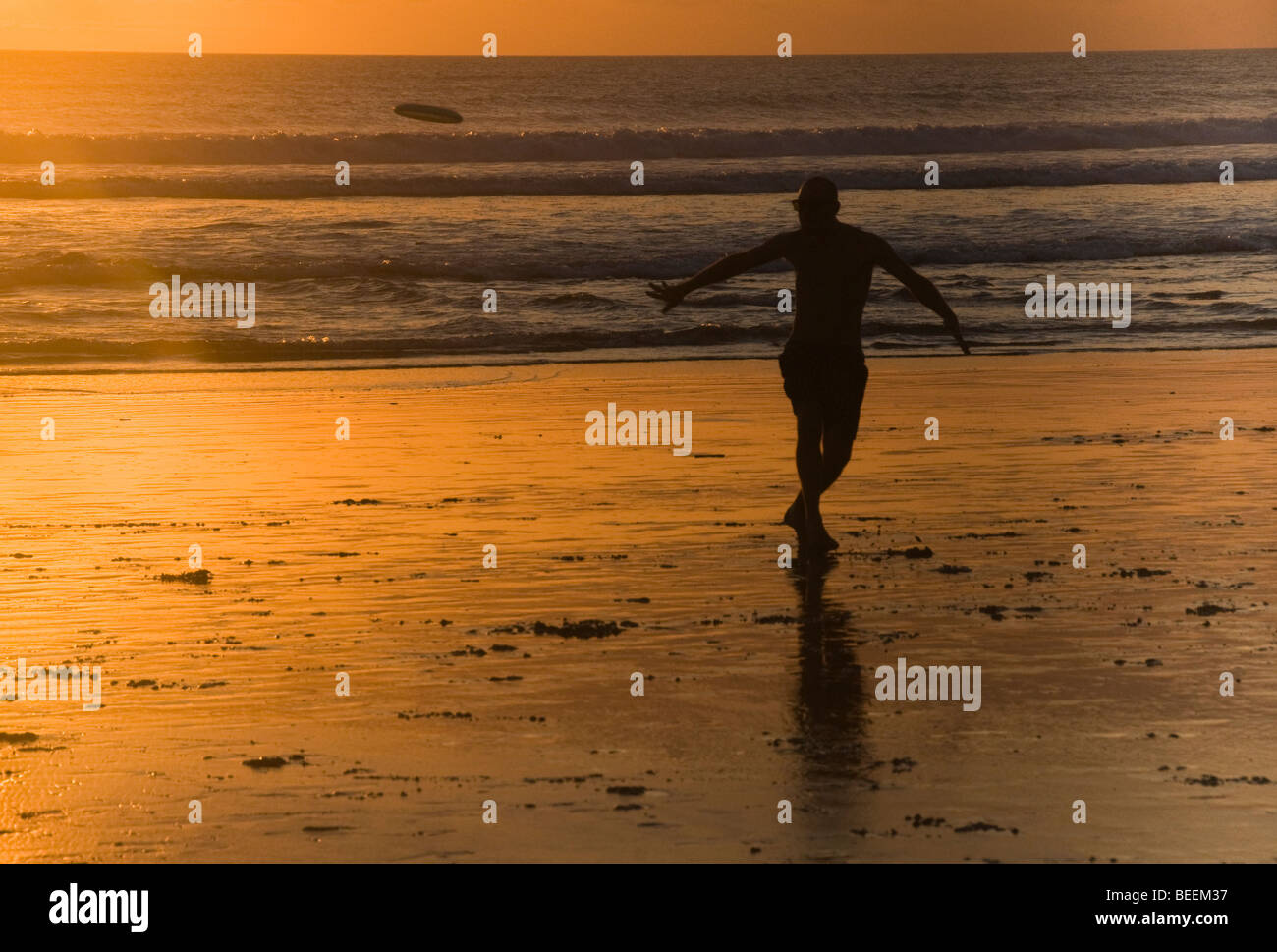 playing frisbee at sunset on Kuta Beach in Bali Indonesia Stock Photo ...