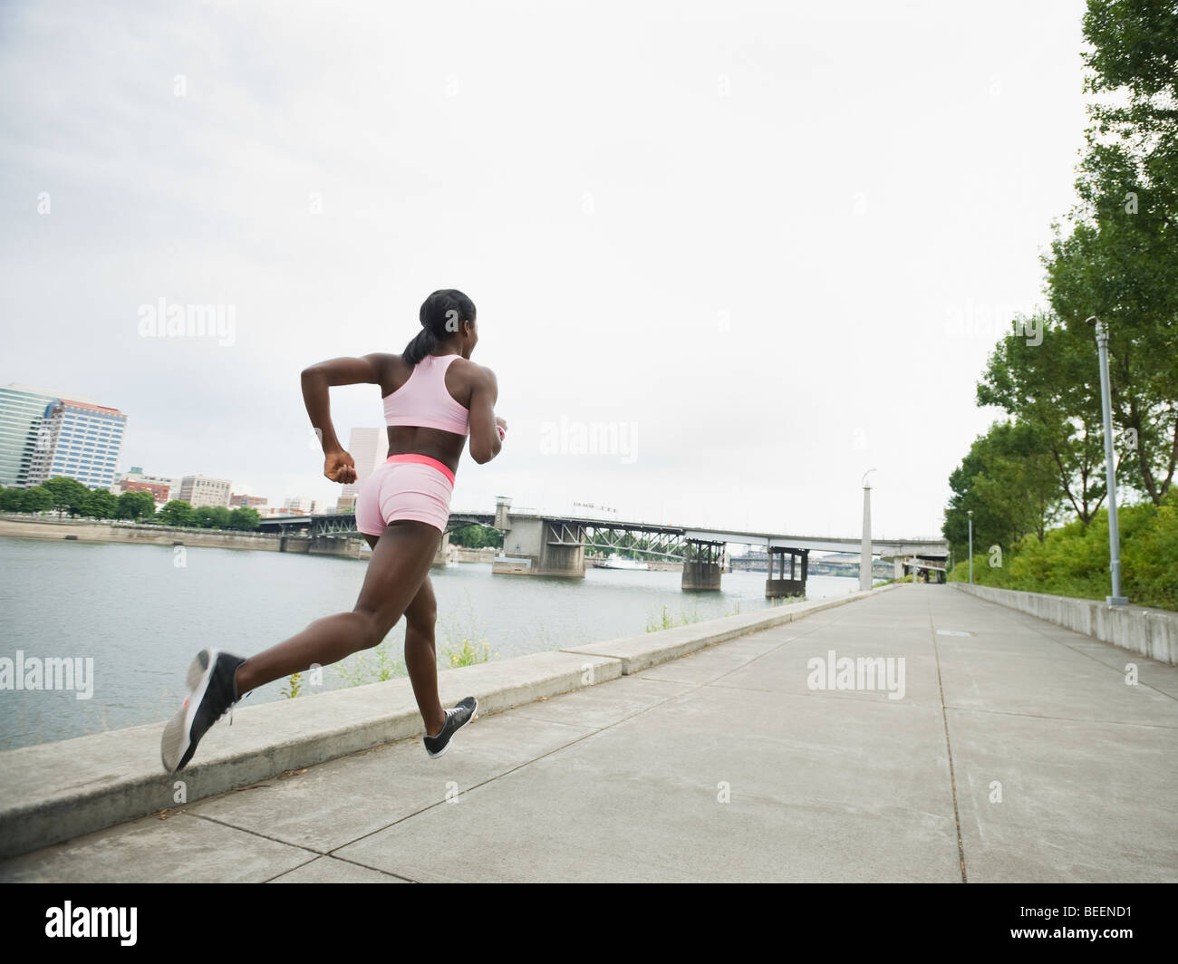 African woman running along urban waterfront Stock Photo - Alamy
