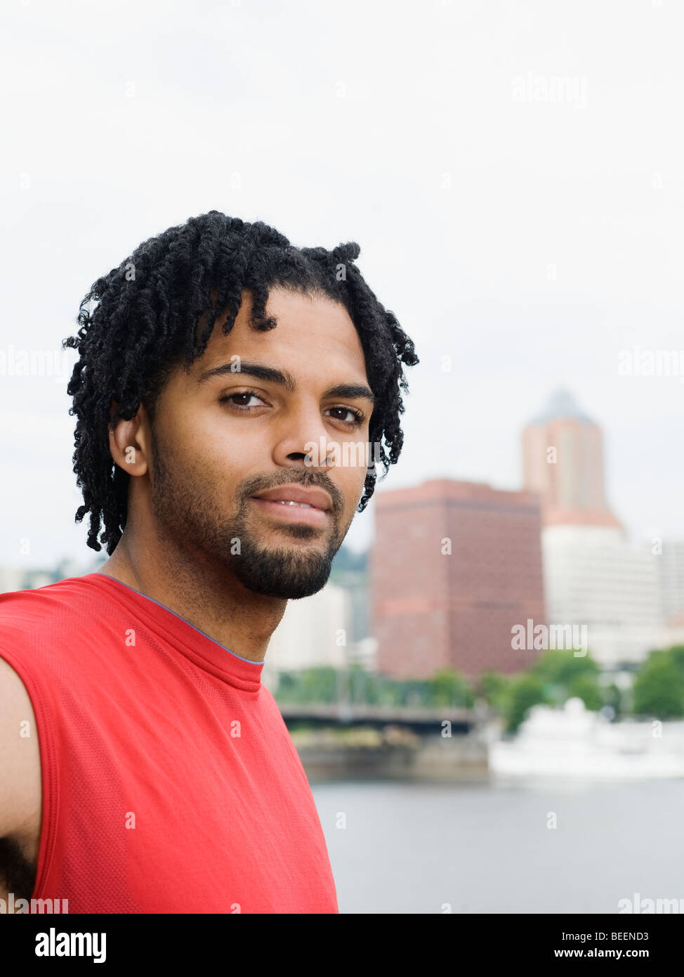 Serious mixed race man with city in background Stock Photo - Alamy
