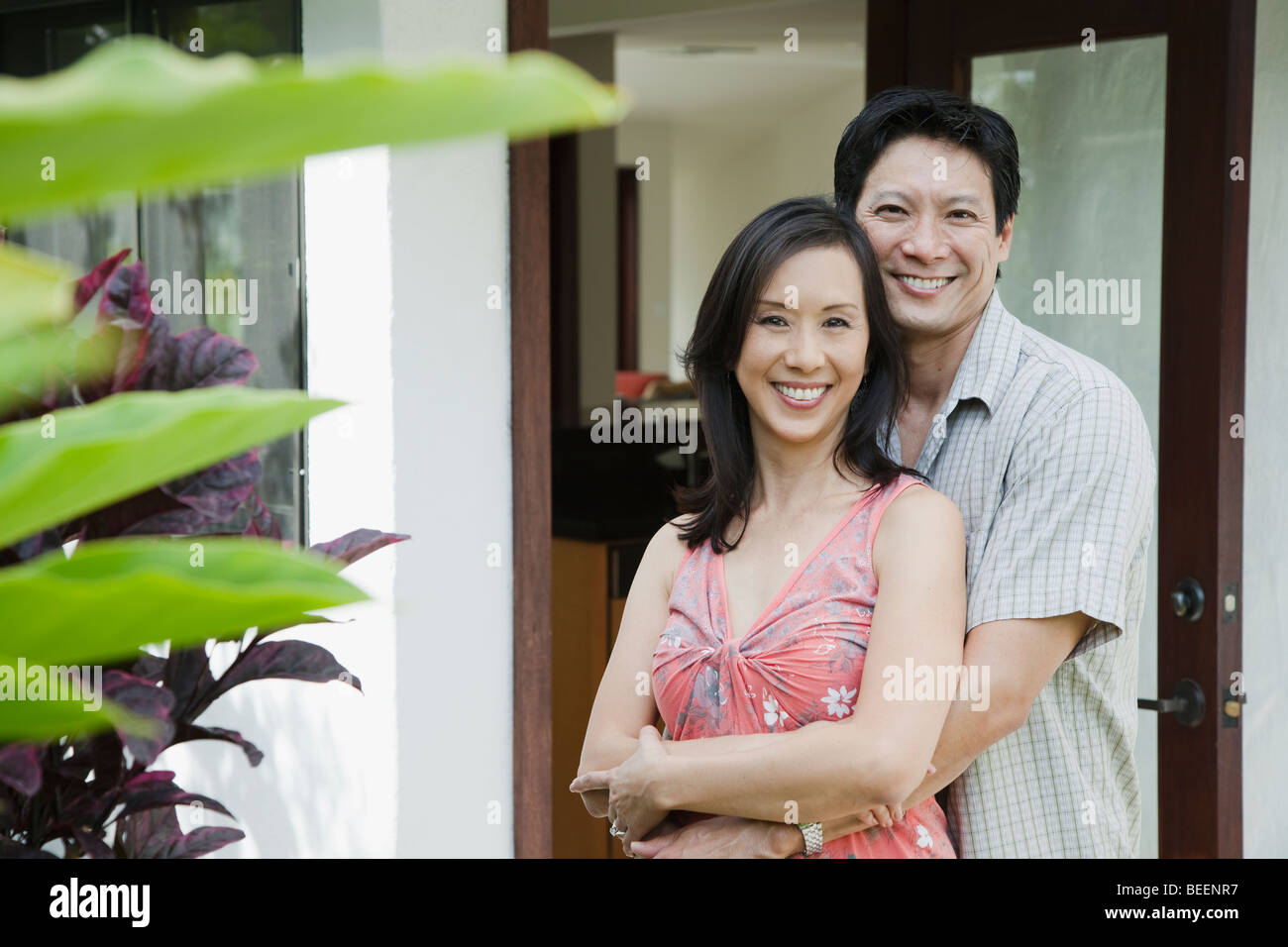 Japanese couple hugging on patio Stock Photo - Alamy