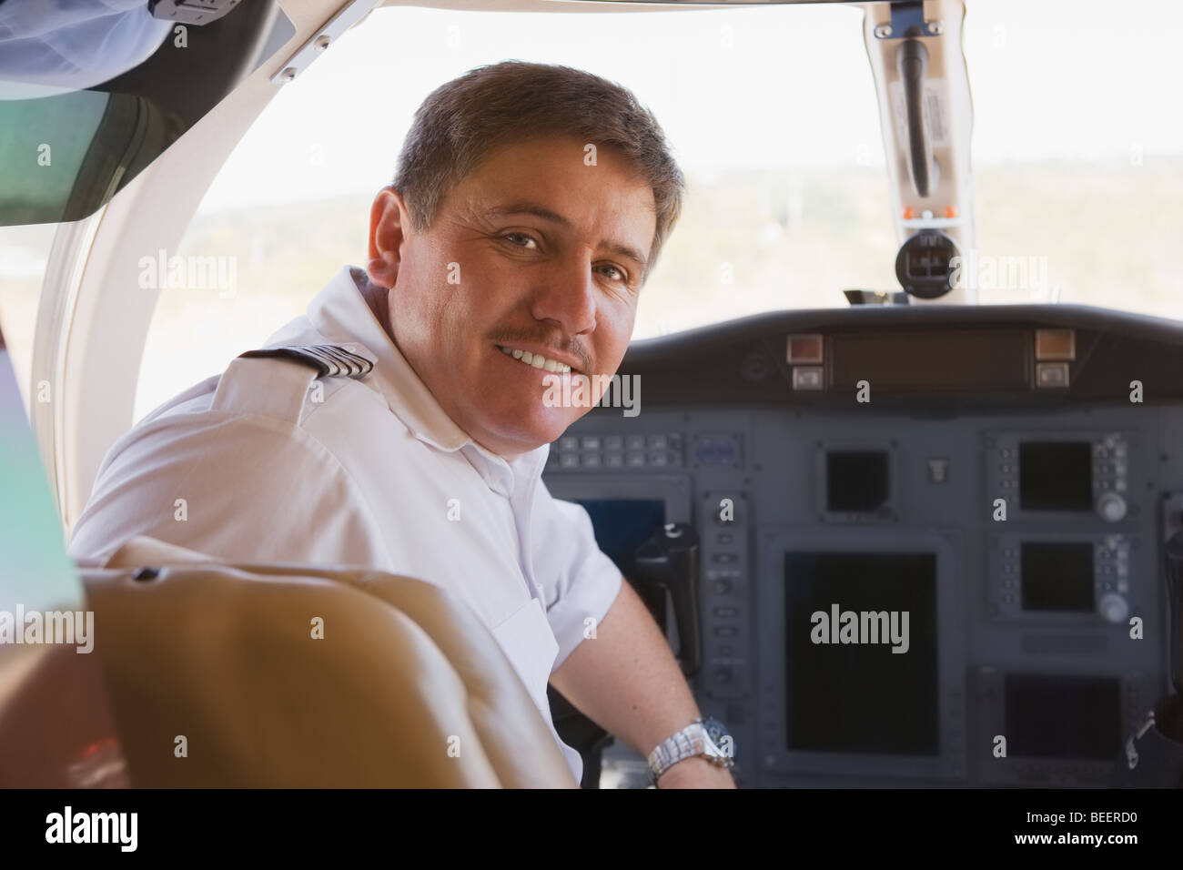 Hispanic pilot in cockpit Stock Photo - Alamy
