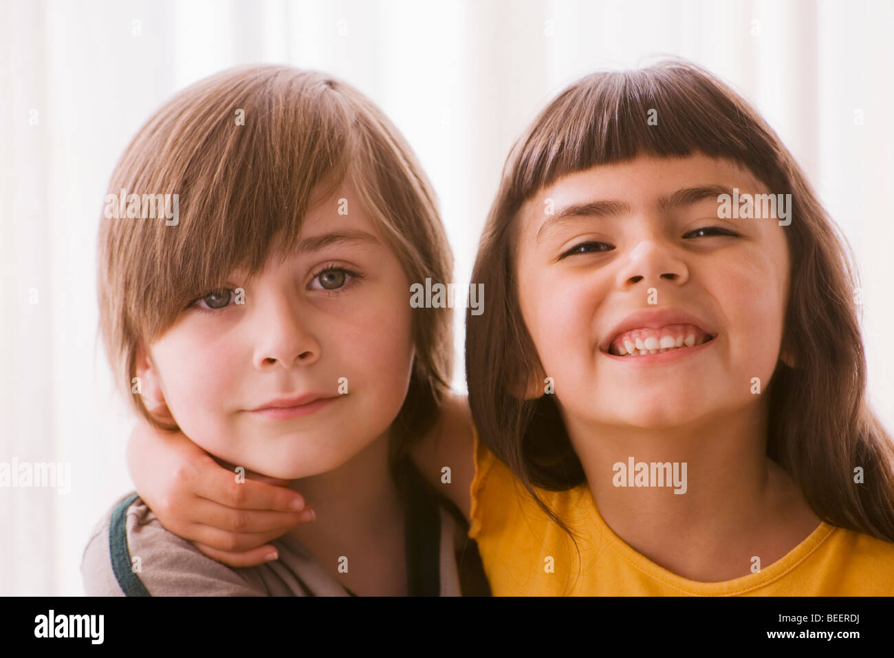 Hispanic boy and girl hugging Stock Photo - Alamy