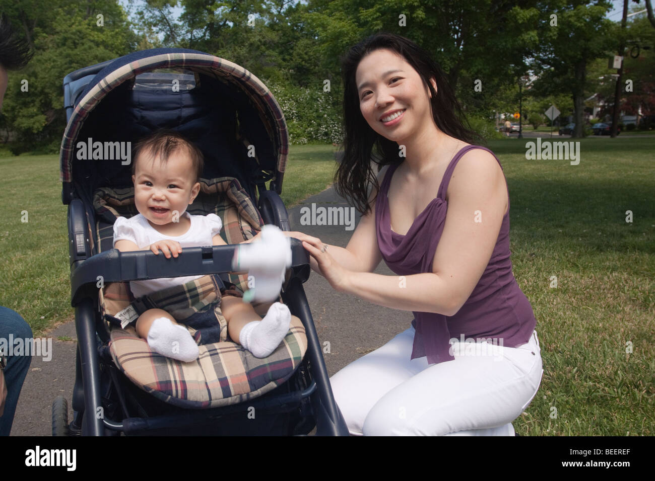 Chinese mother and baby in stroller at park Stock Photo - Alamy