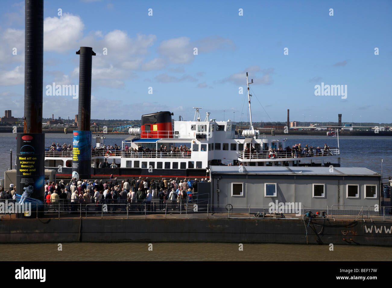 tourists and commuters queue up at the pier head floating ferry ...
