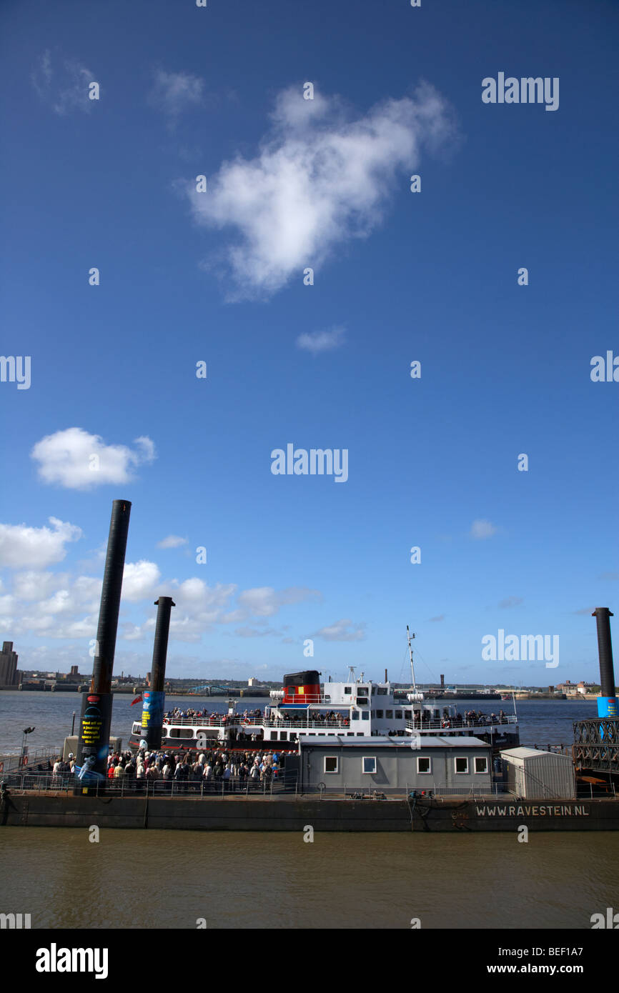 tourists and commuters queue up at the pier head floating ferry ...