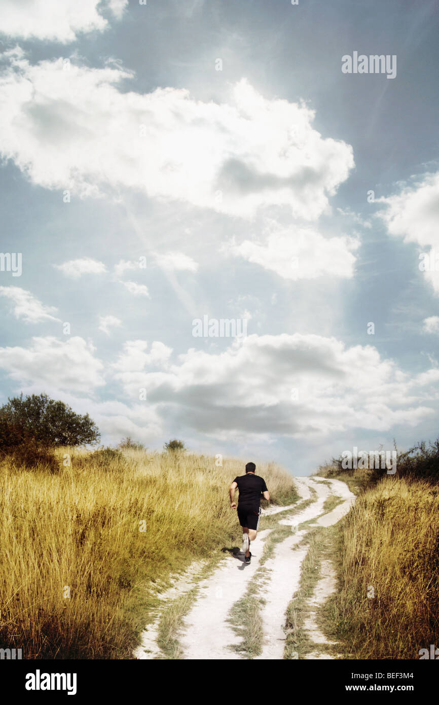 man running up a track Stock Photo - Alamy