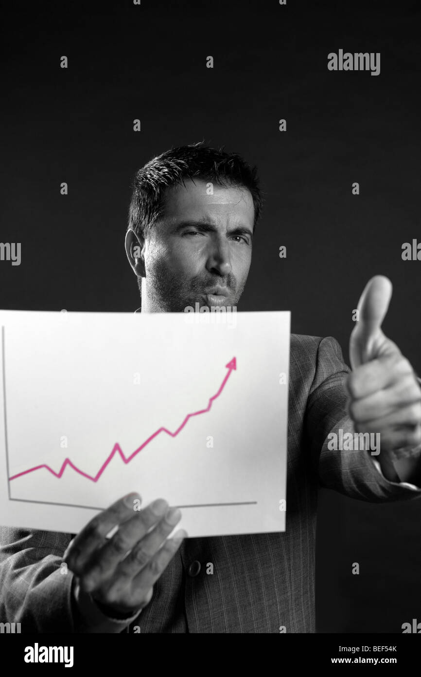 Businessman with good sales reports graph, studio shot black background ...