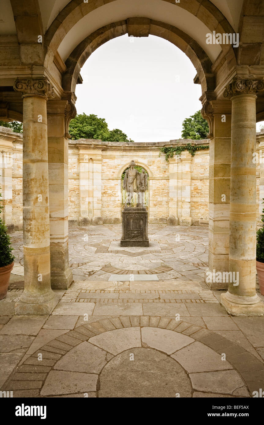 An Italian style statue seen through an archway in the Hever Castle ...