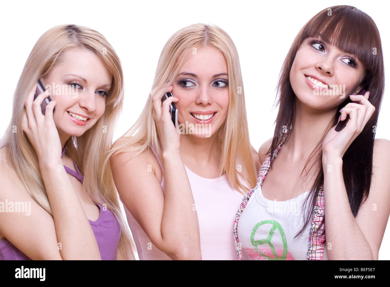 three girls with phone on a white background Stock Photo - Alamy