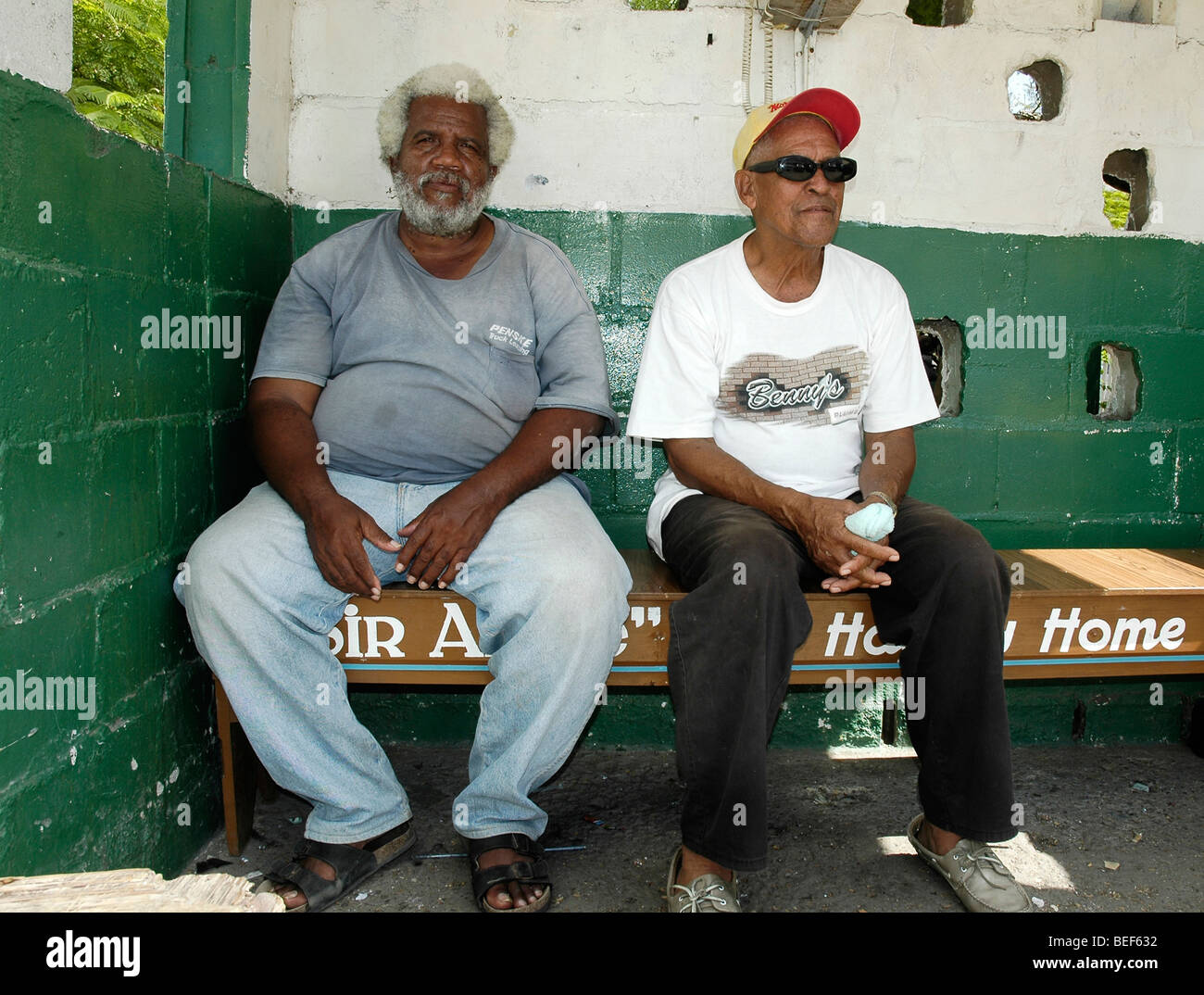 two old men waiting for the bus, Belize City Stock Photo - Alamy
