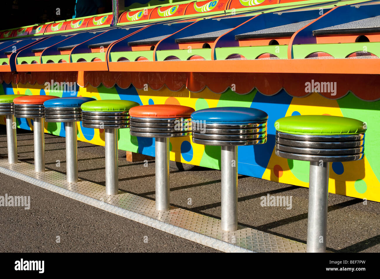 Evergreen State Fair games along boardwalk fair stools lined up forgame ...