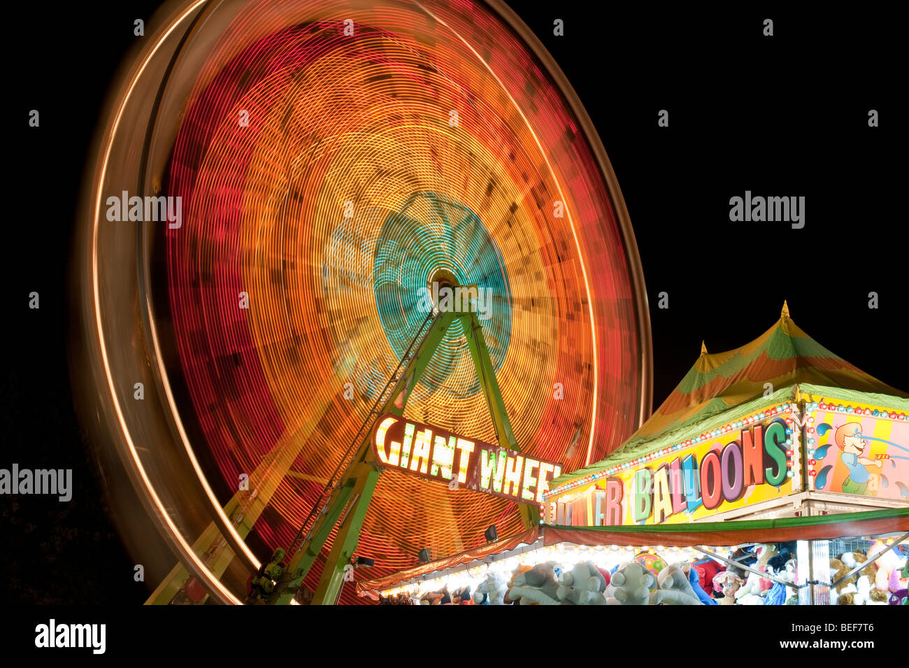 Evergreen State Fair ferris wheel at night with rides and motion and ...