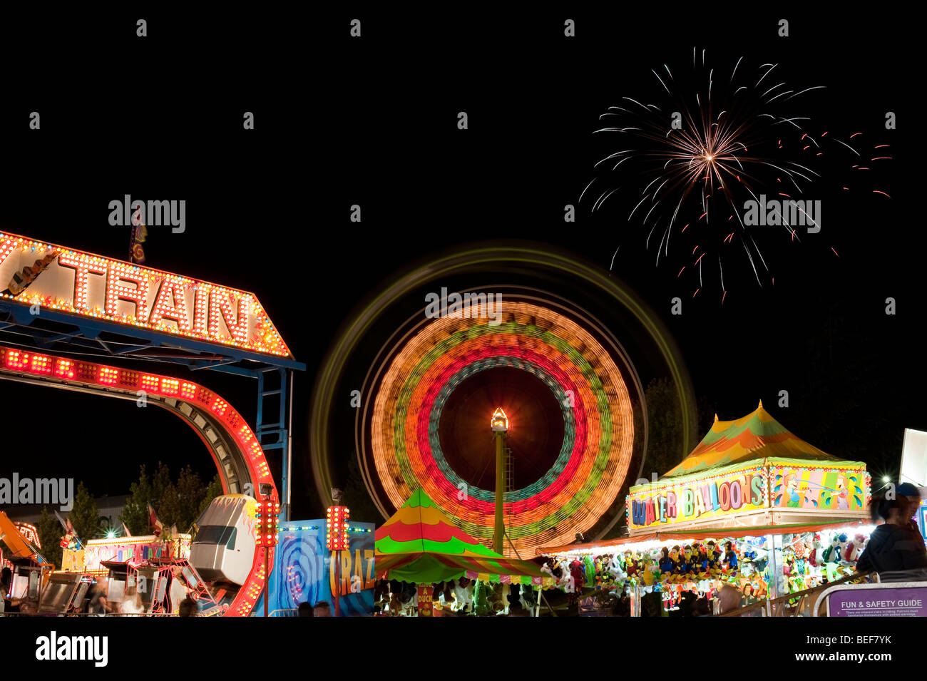 Evergreen State Fair ferris wheel at night with rides and motion with ...