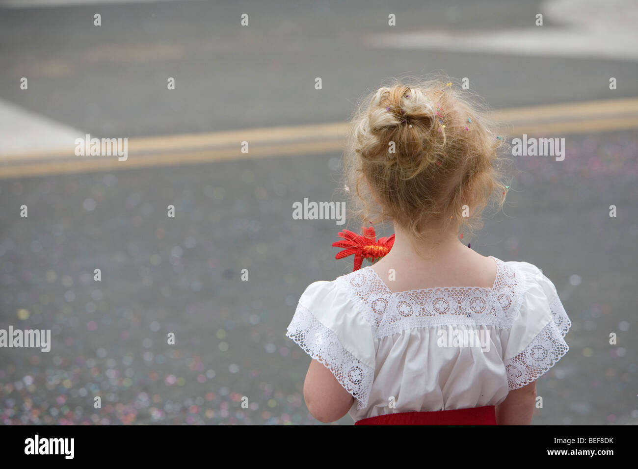 Little girl with a red flower Stock Photo - Alamy