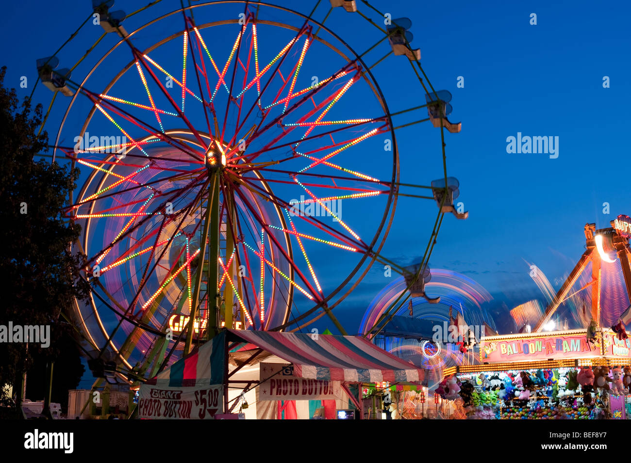Evergreen State Fair at twilight with Ferris Wheel and amusement rides ...