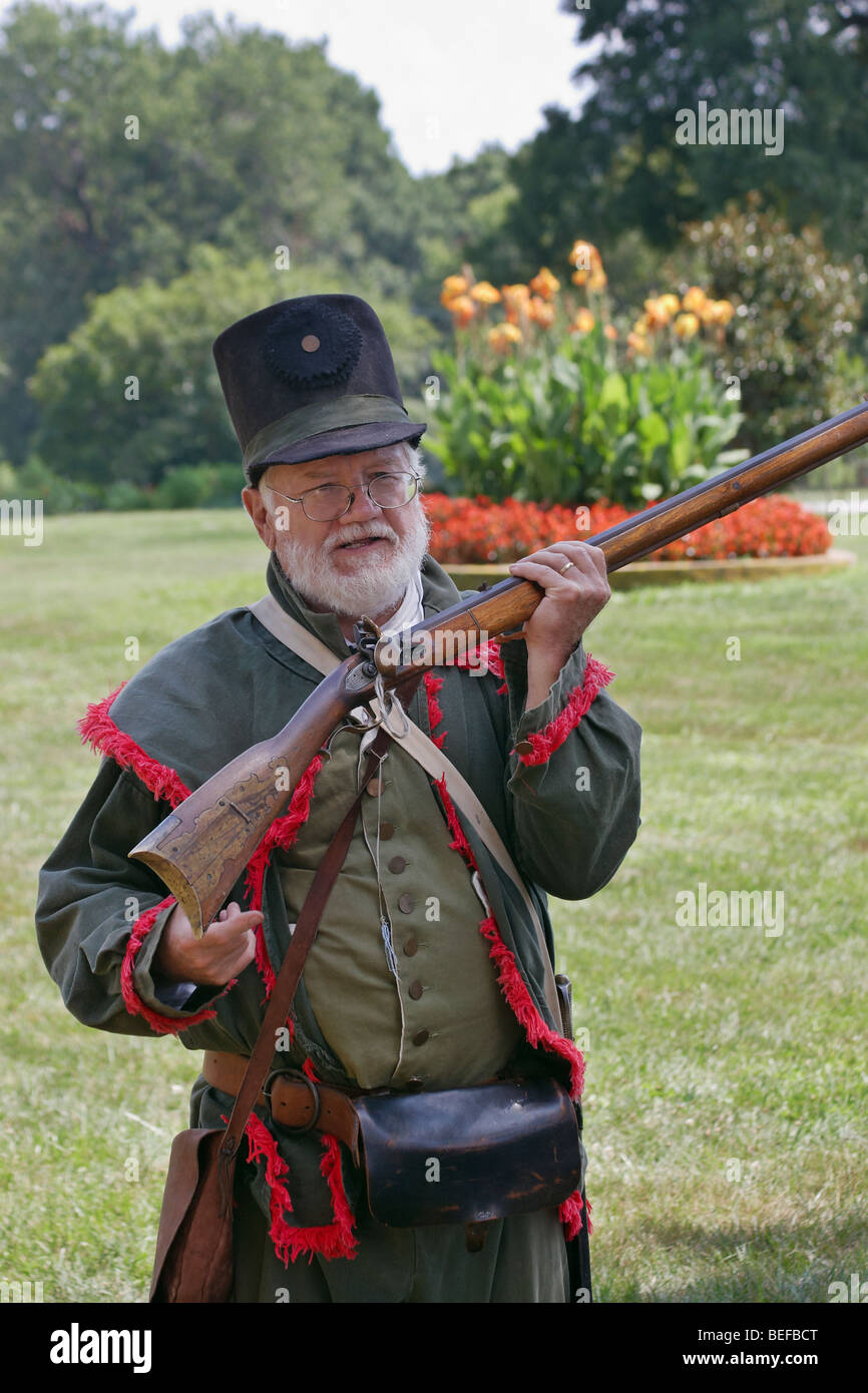 A costumed militia man re-enactor giving a rifle demonstration at the ...