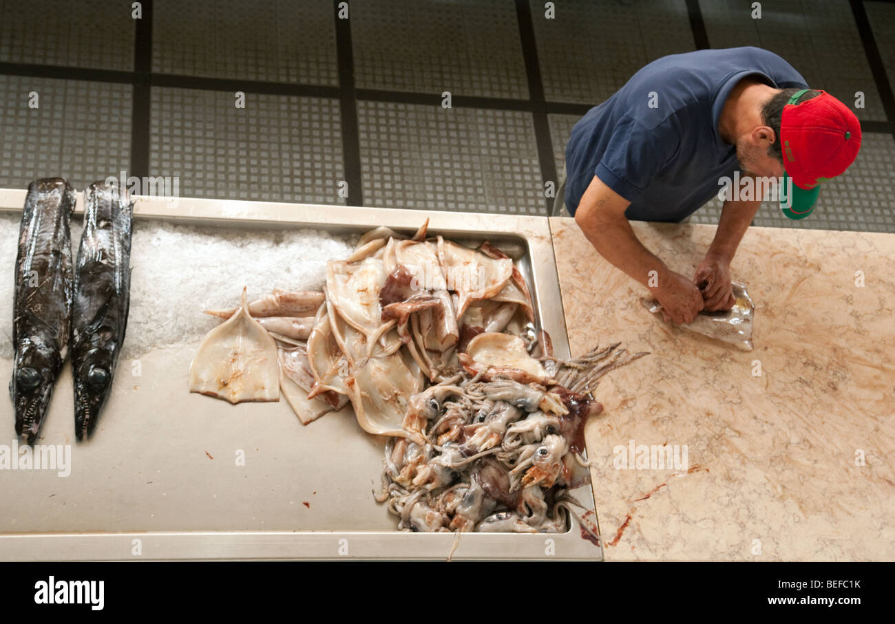 Fishmonger preparing squid, The Market, Funchal, Madeira Stock Photo ...