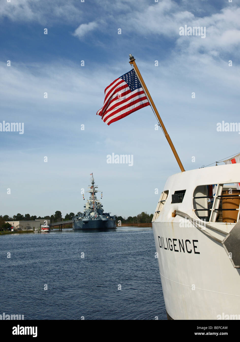 back of Coast Guard Cutter Diligence with USA flag waving on Cape Fear ...
