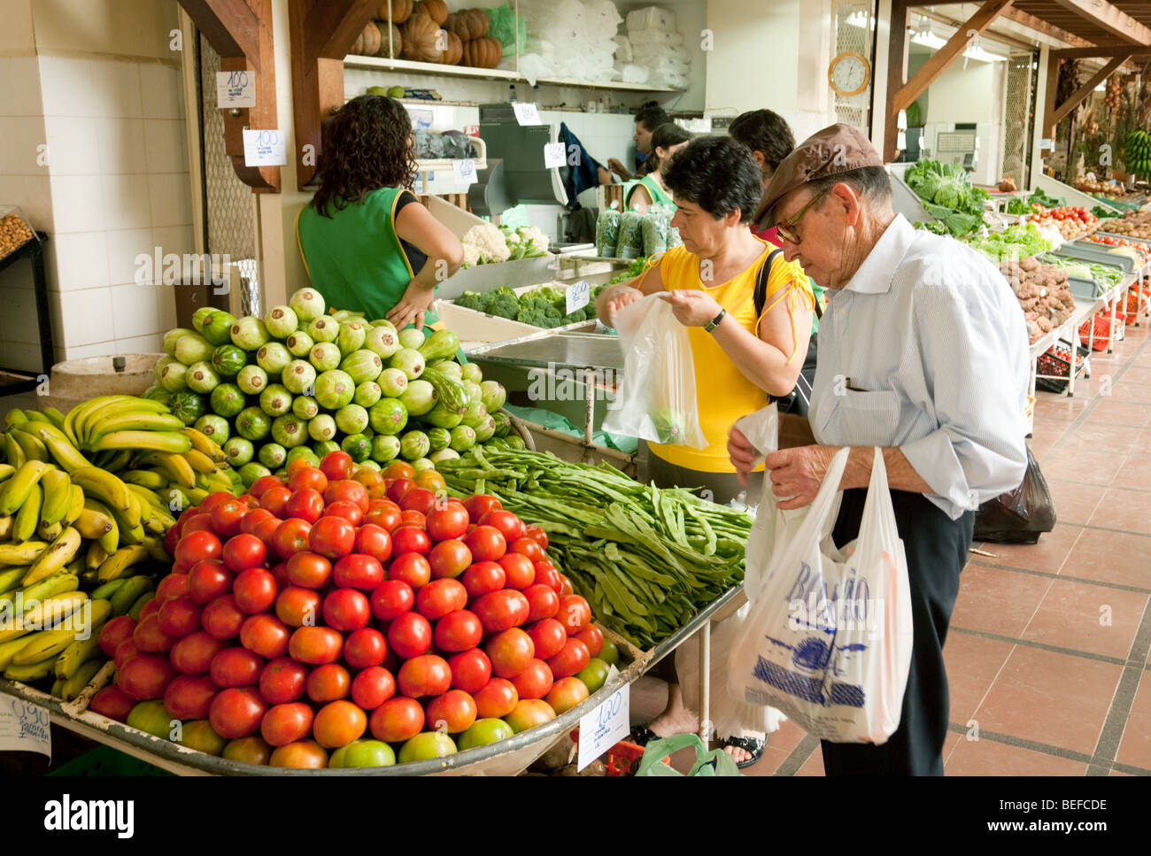 People buying fruit and veg at the covered market in Funchal, Madeira ...