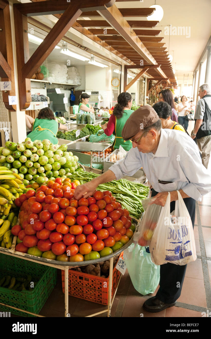 People buying fruit and veg at the covered market in Funchal, Madeira ...