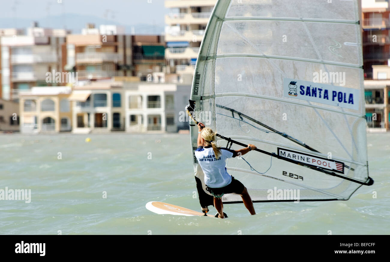 female windsurfer in front of seafront buildings at the Formula ...