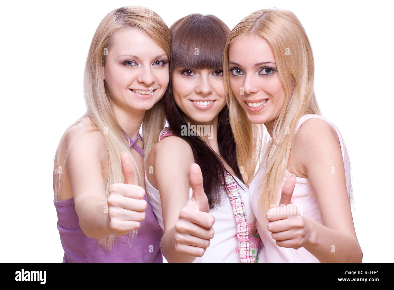three girls together giving thumbs-up on a white background Stock Photo ...