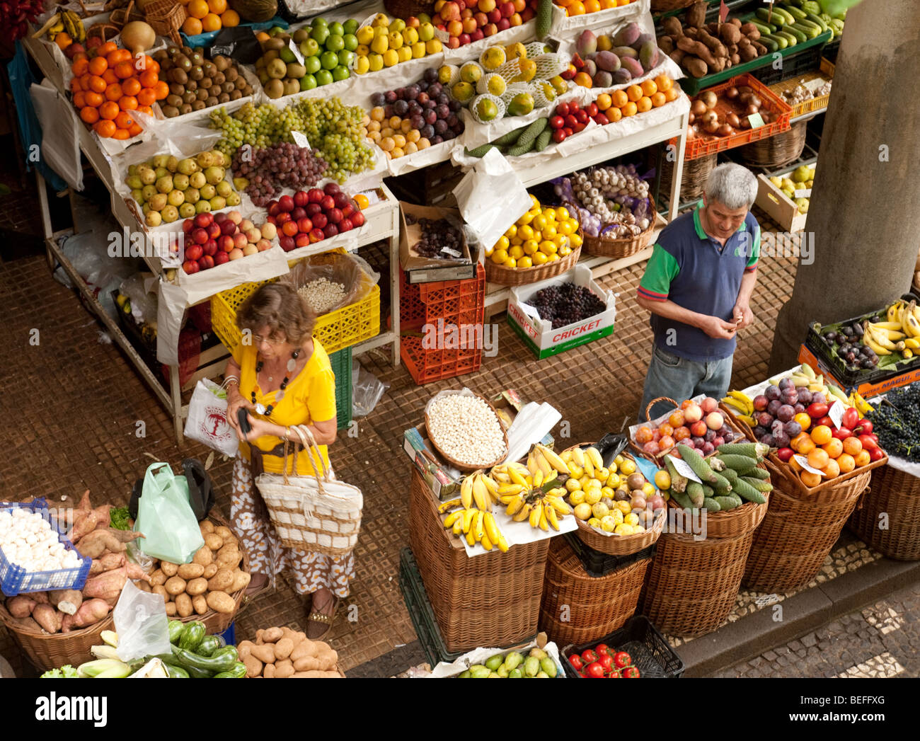 People buying fruit and veg at the covered market in Funchal, Madeira ...