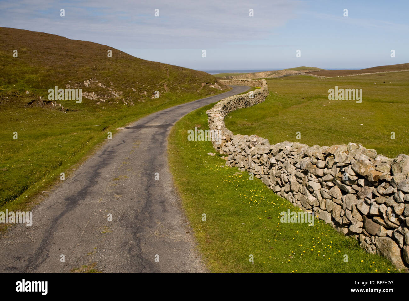 Empty road with dry stone wall on Fair Isle Shetland Stock Photo - Alamy