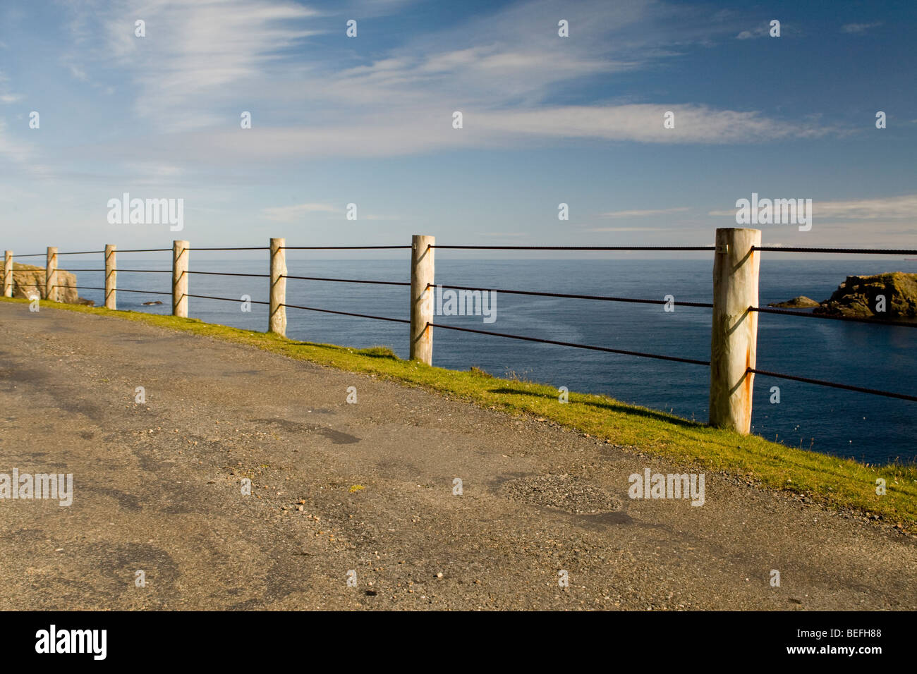 Fence by road on cliff edge Fair Isle Shetland Stock Photo - Alamy