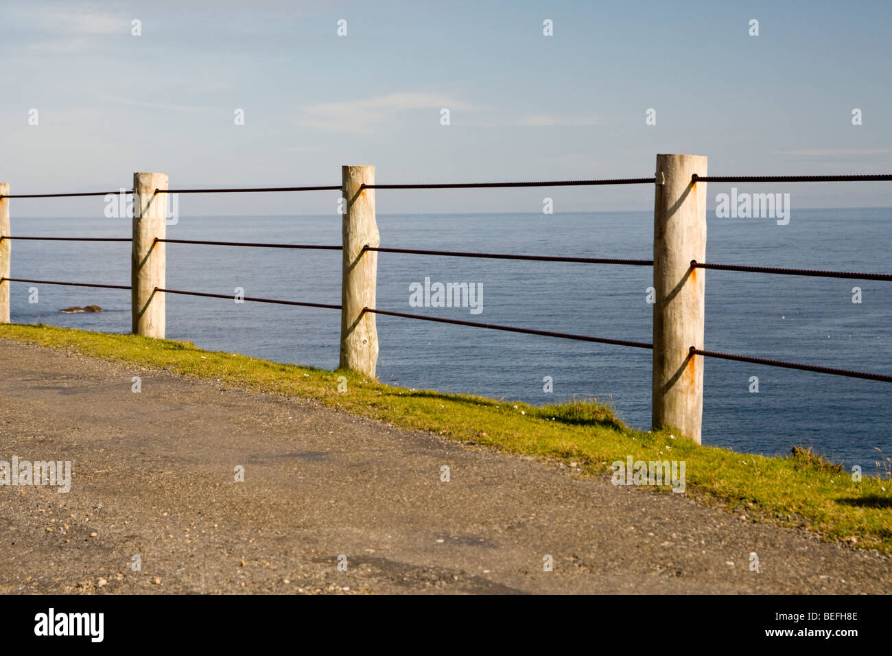 Fence by road on cliff edge Fair Isle Shetland Stock Photo - Alamy