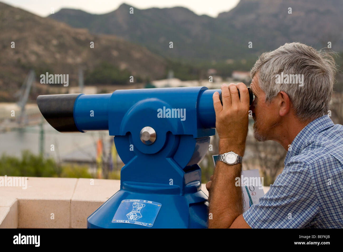 Man using telescope at old fortress Cartagena in Spain Stock Photo - Alamy