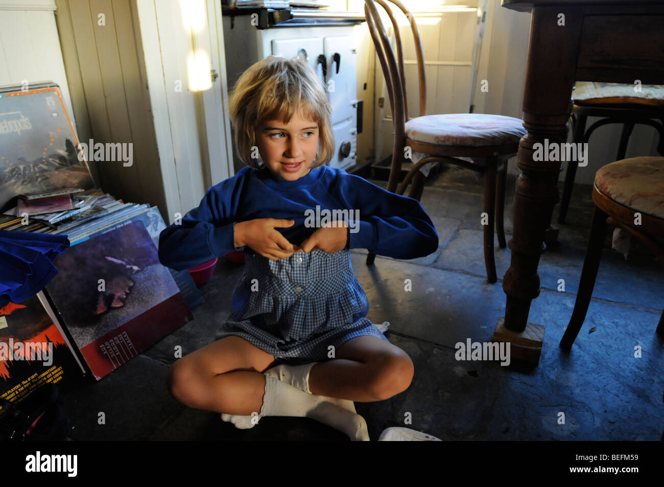 Young girl getting dressed for school at home Stock Photo - Alamy