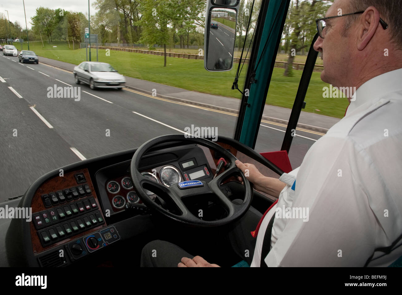 Passenger view of coach driver and road ahead Stock Photo - Alamy