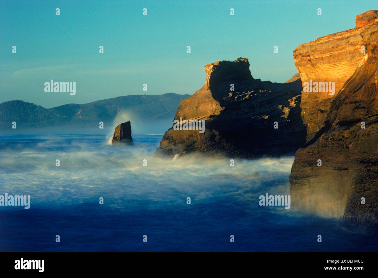 Waves painting rock walls at Cape Kiwanda on Oregon coast Stock Photo ...
