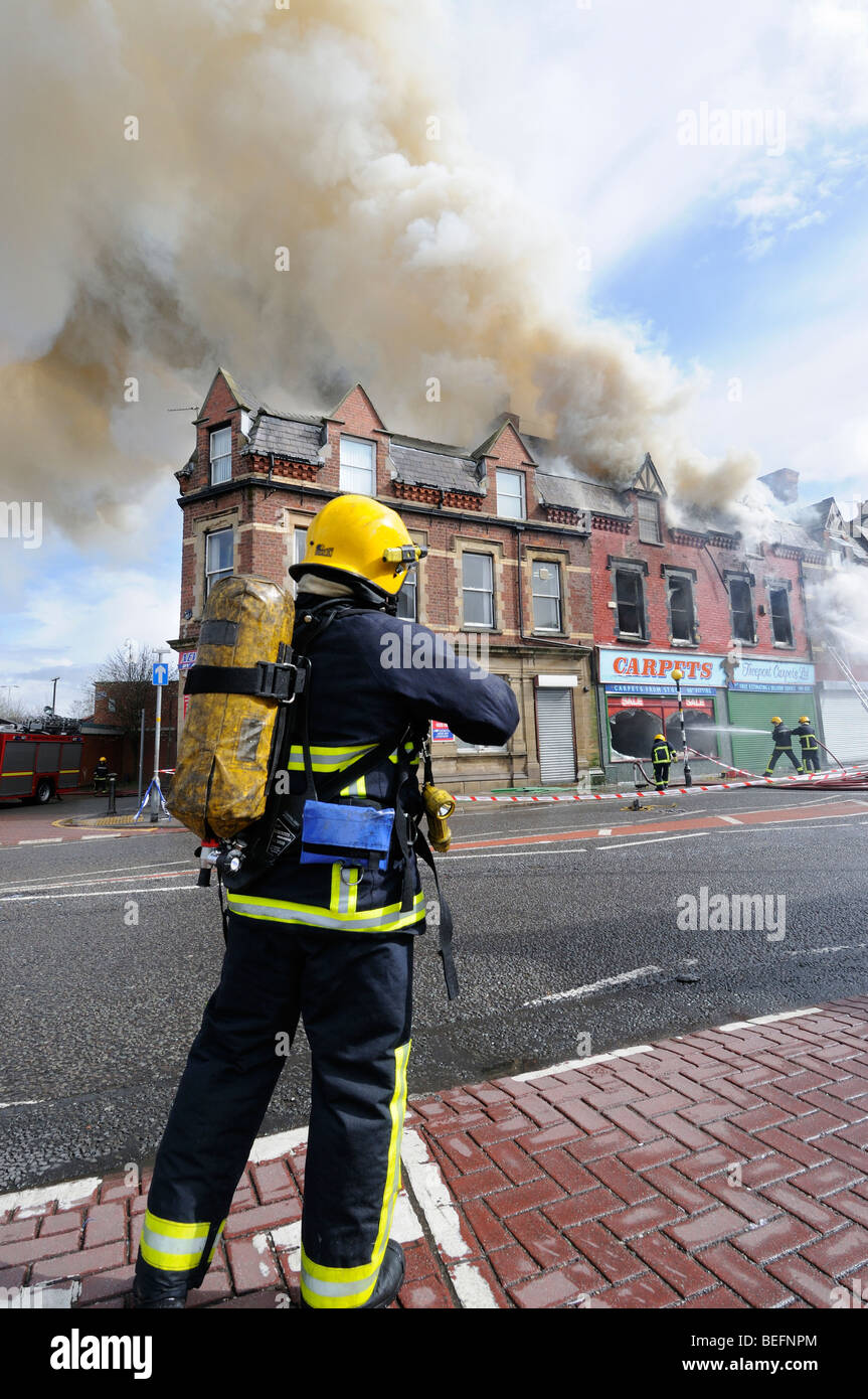 Fireman in Breathing Apparatus at large shop fire in UK Stock Photo - Alamy