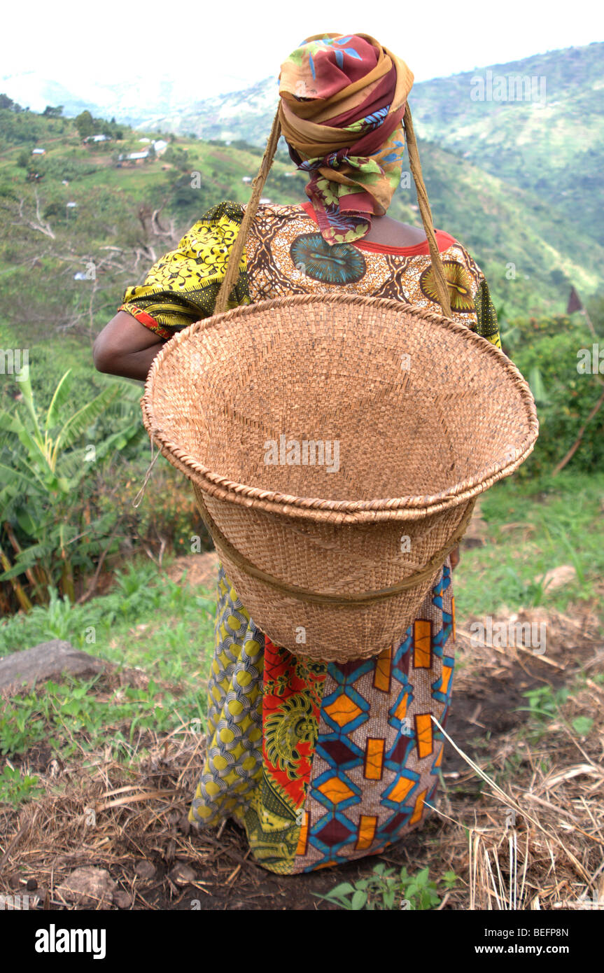 Bakonzo woman going to work in the fields with a basket on her back ...