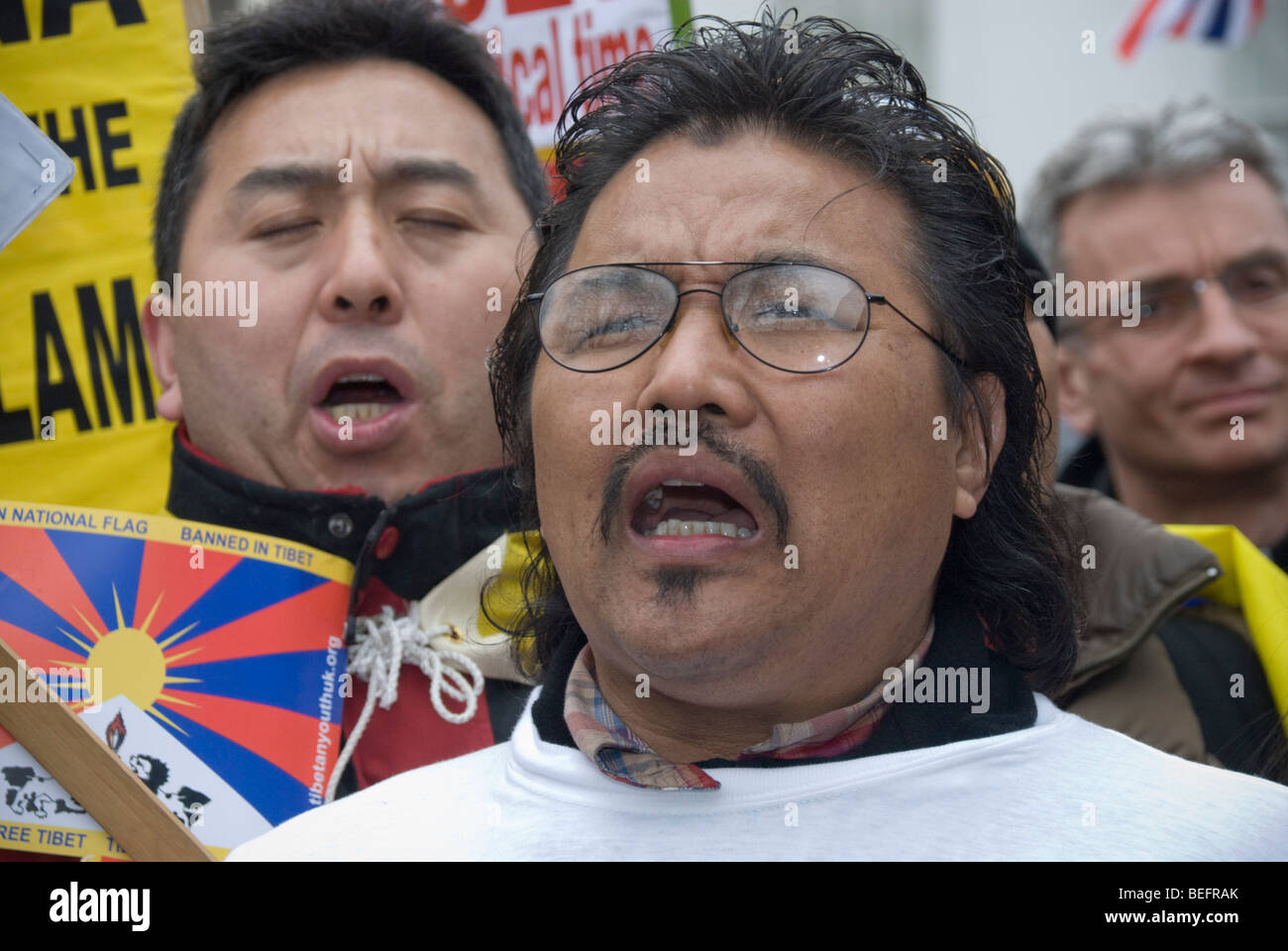 Tibetan men shout at a packed rally in London with the Tibetan Freedom ...
