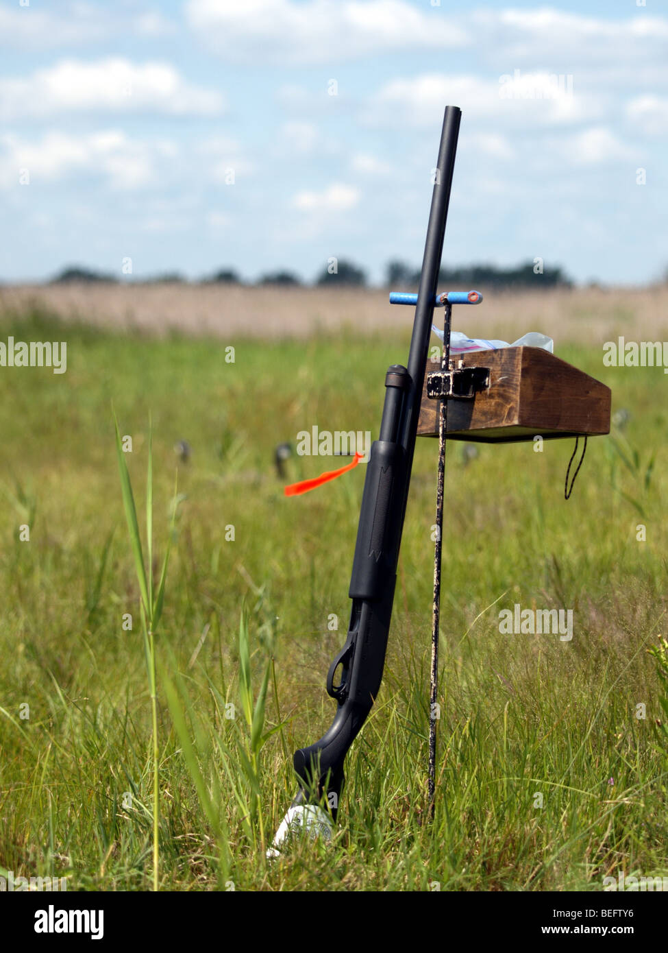 Rifle leaning against gun stand during a United Kennel Club Hunt Test ...
