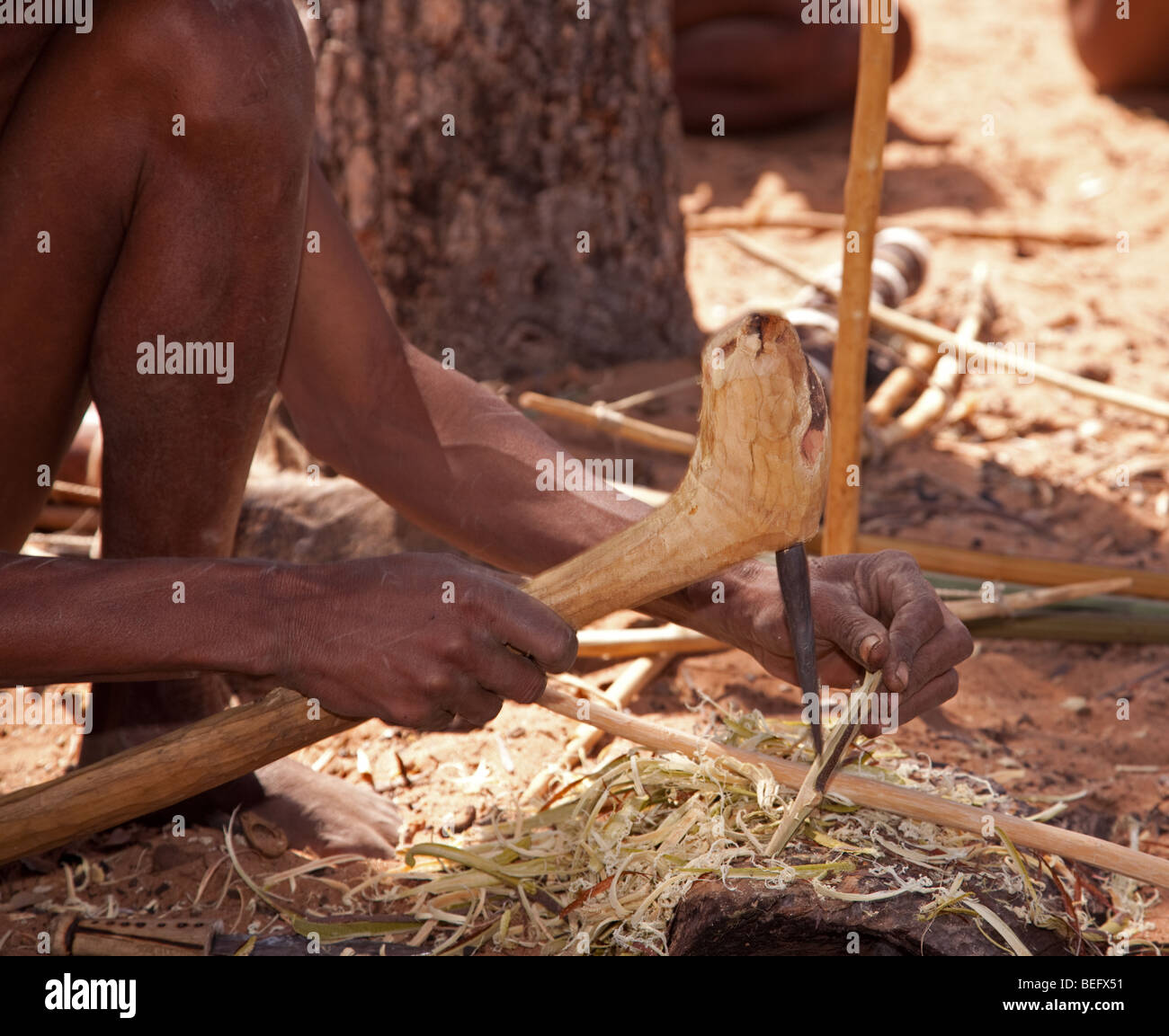 San Village. Manufacturing a bow and arrow the traditional way Stock ...