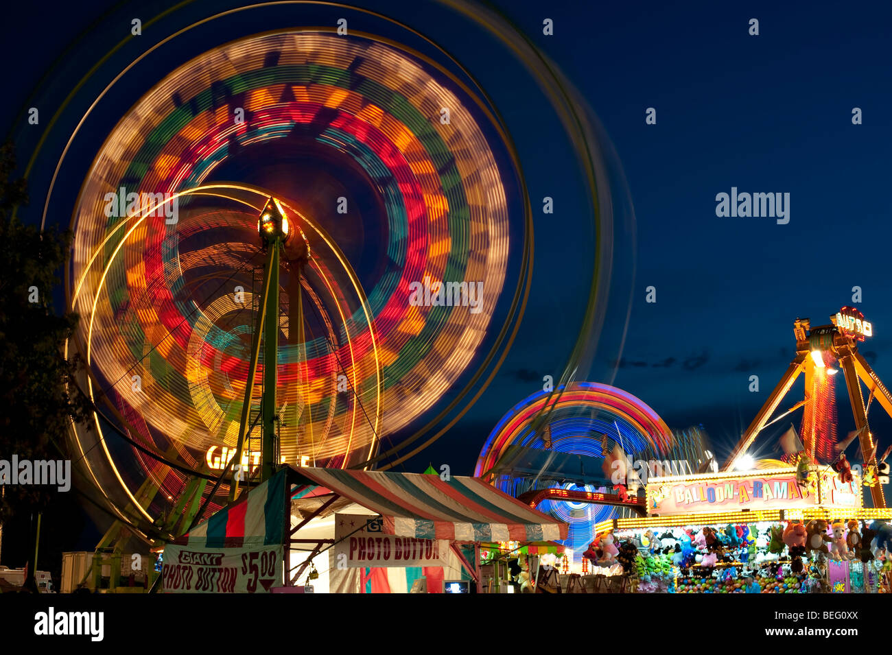Evergreen State Fair at twilight with Ferris Wheel and amusement rides ...