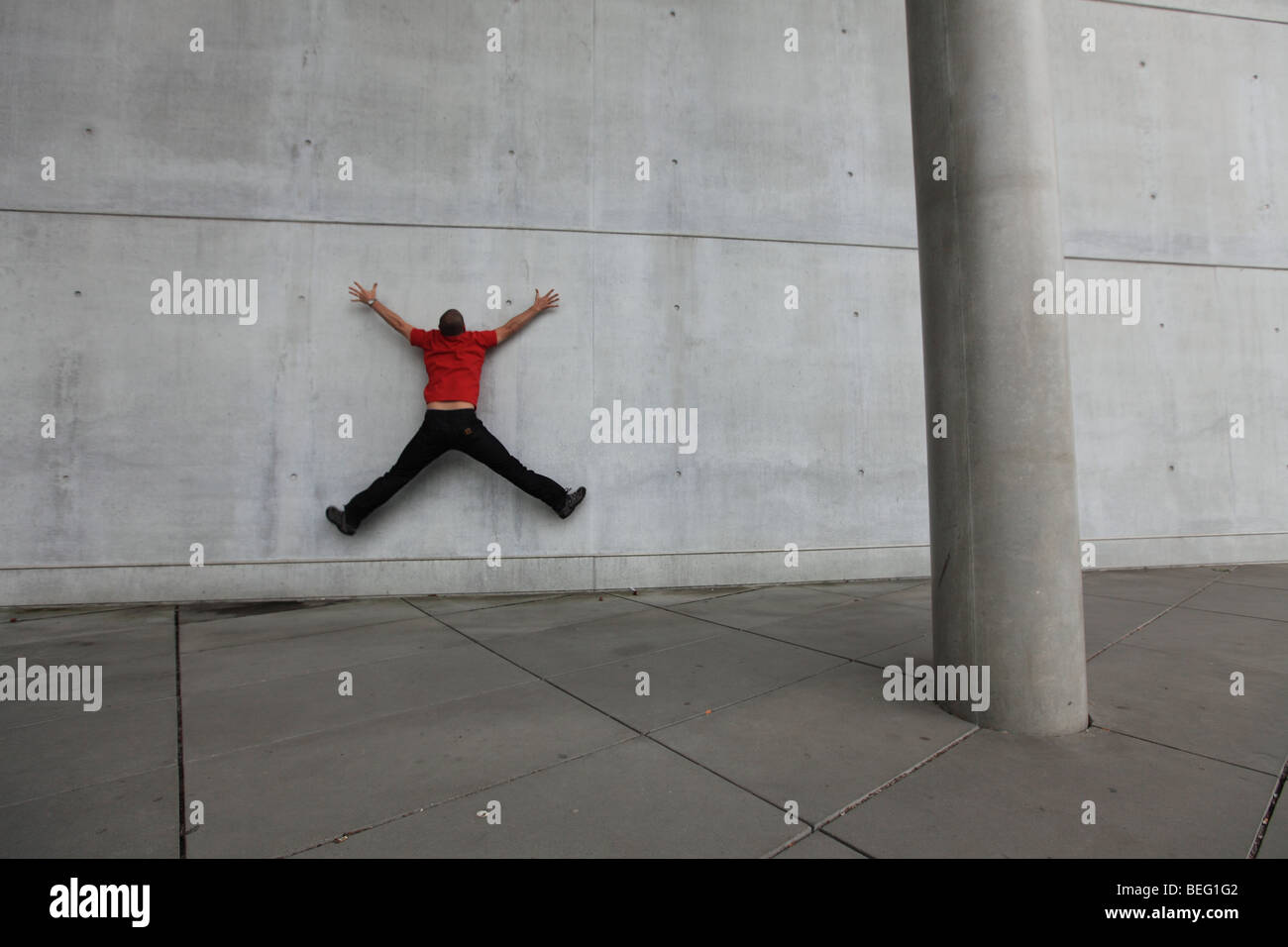 Man Jumping against a wall Stock Photo - Alamy
