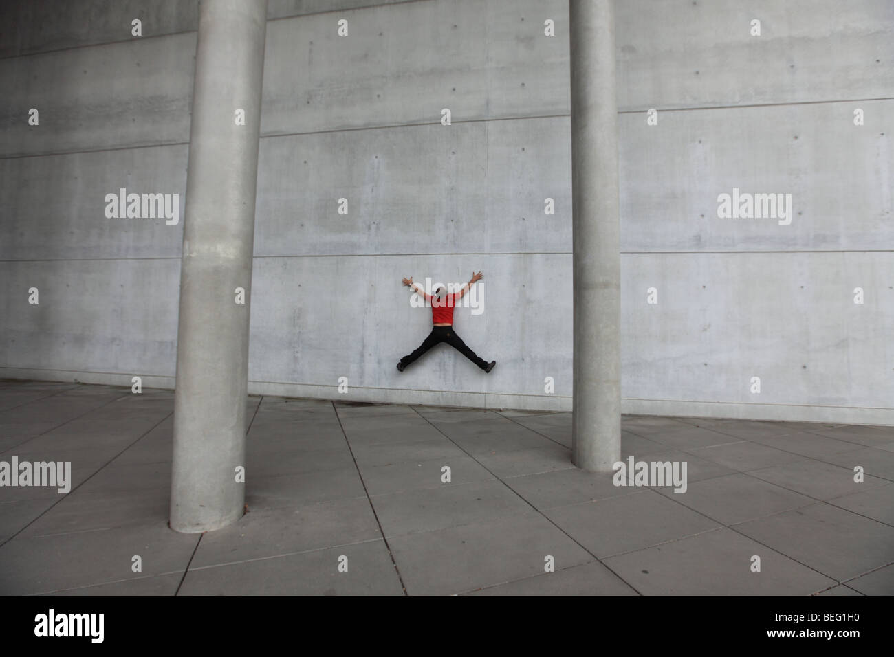 Man Jumping against a wall Stock Photo - Alamy