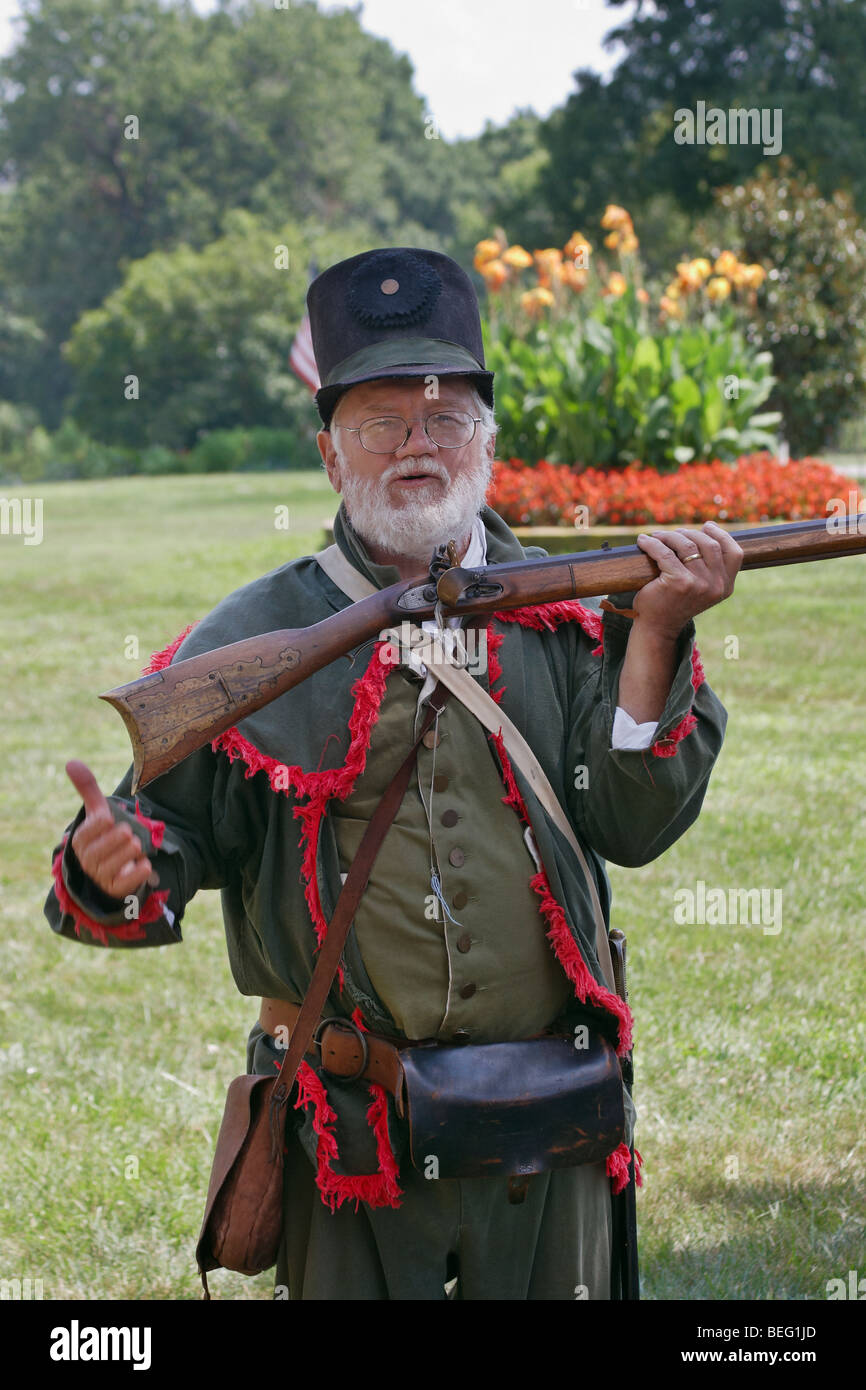 A costumed militia man re-enactor giving a rifle demonstration at the ...