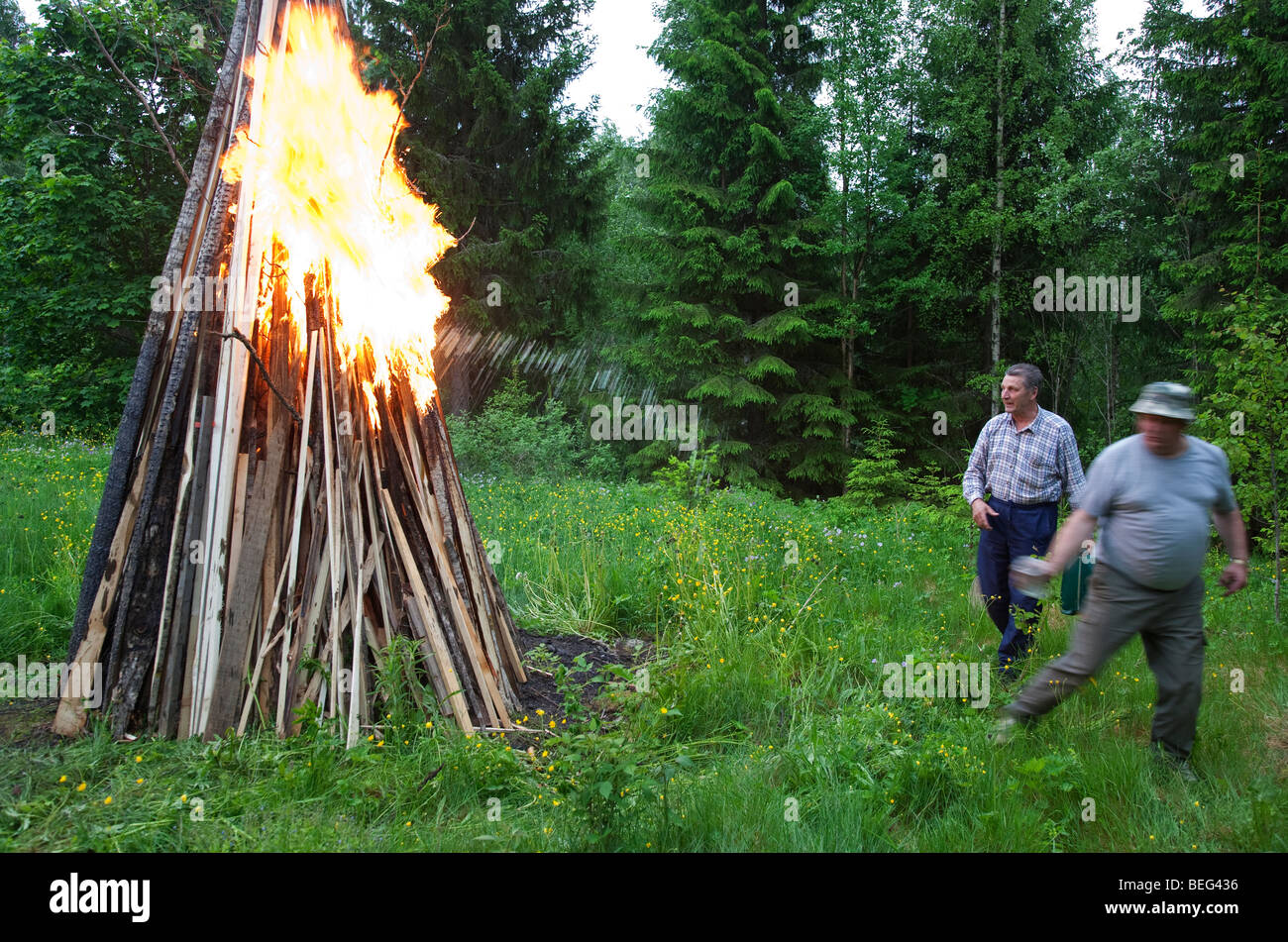 Throwing gasoline into bonfire , Finland Stock Photo - Alamy