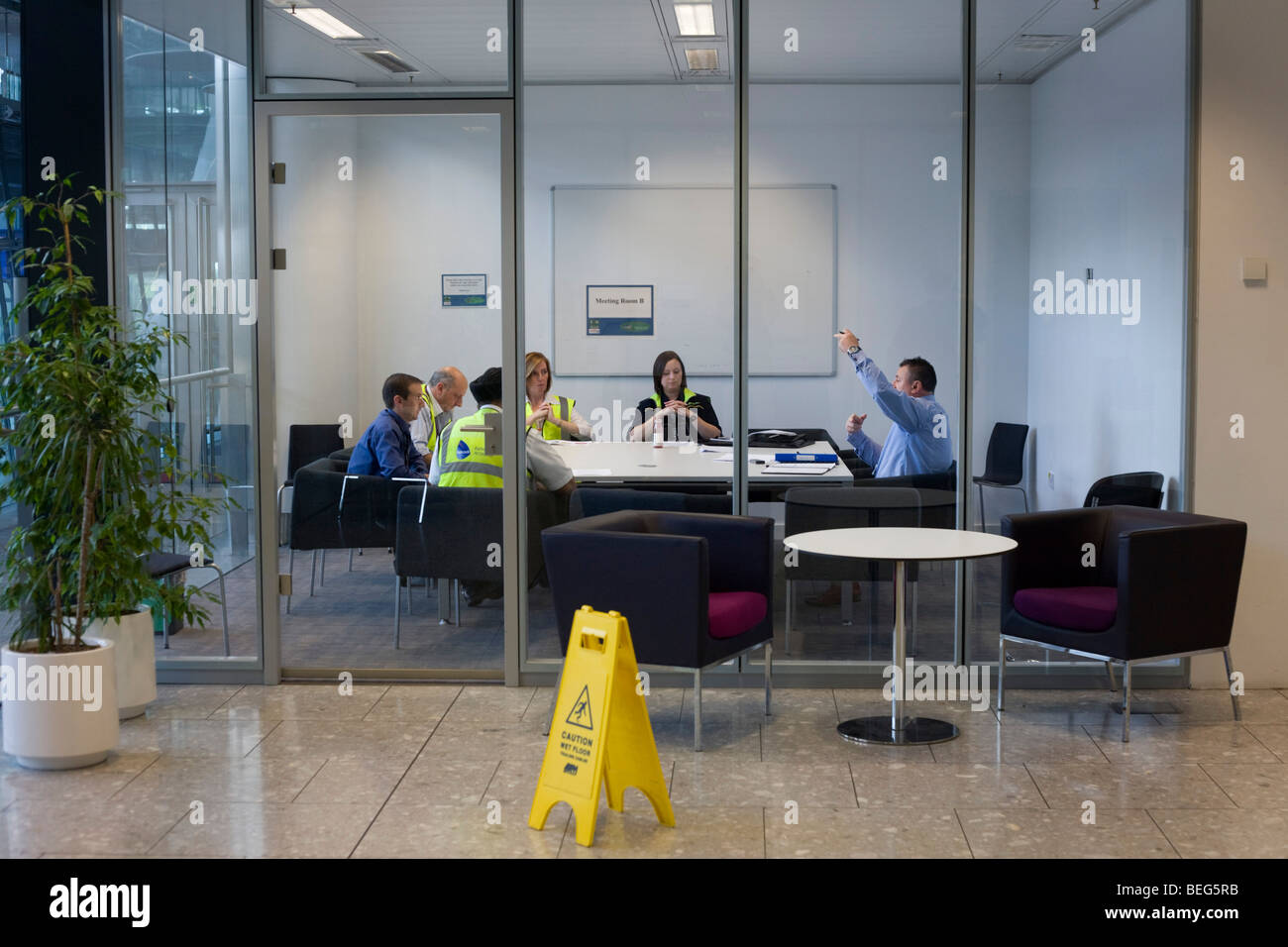 An employee raises his hand during airport operator BAA's company ...