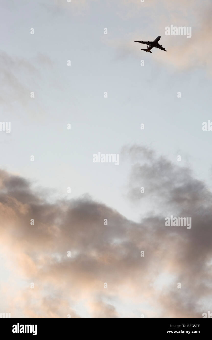 In the top-right corner of the image, an airliner passes overhead in an ...